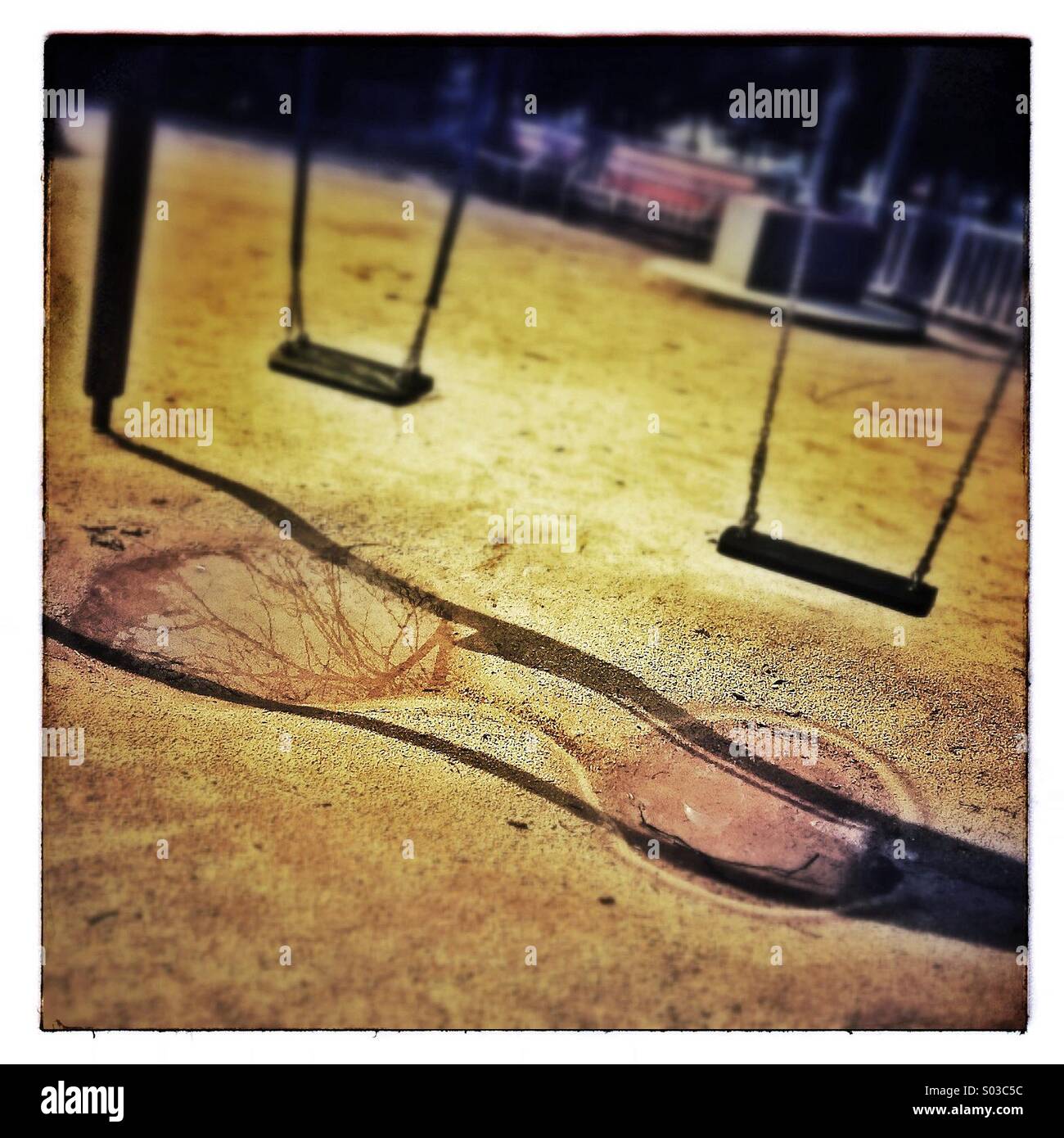 Swing chairs in a playground Stock Photo - Alamy
