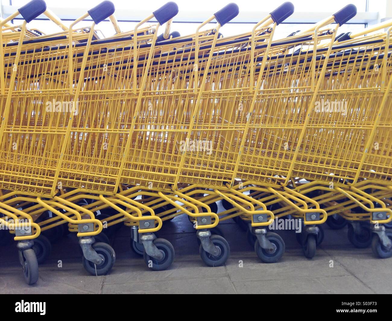 Yellow shopping trolley Stock Photo - Alamy
