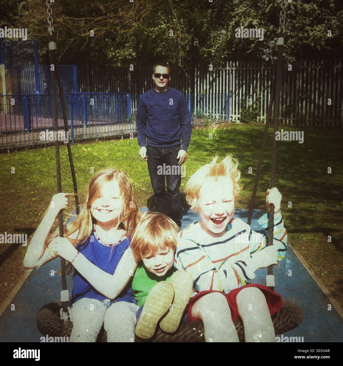 Children on a Swing Stock Photo - Alamy