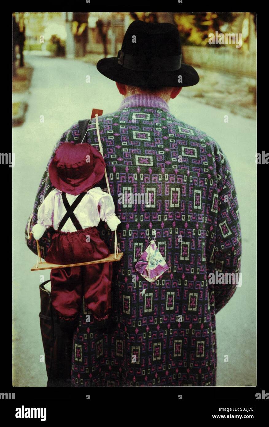 Elderly man seen from the back carrying a puppet Stock Photo - Alamy