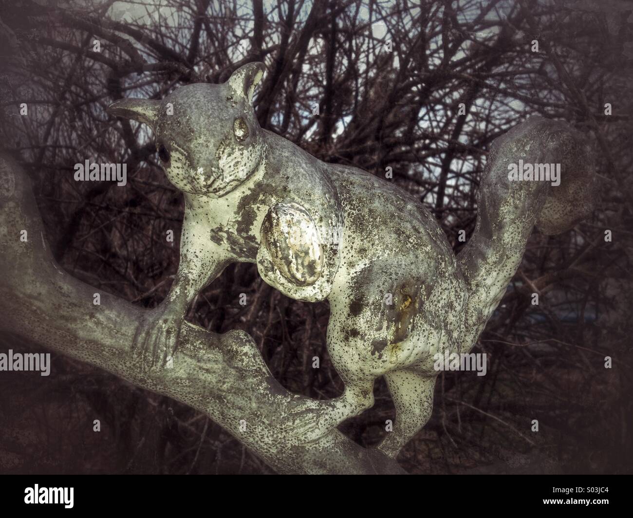 Old garden ornament statue of squirrel holding nut Stock Photo - Alamy