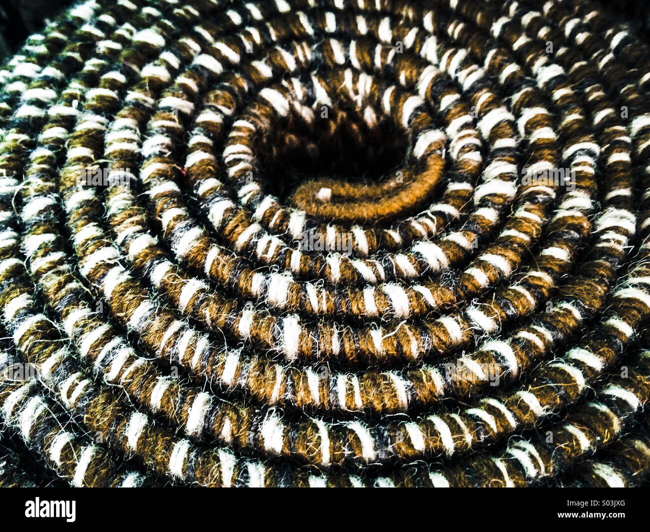 Close up of a rolled up rug Stock Photo - Alamy