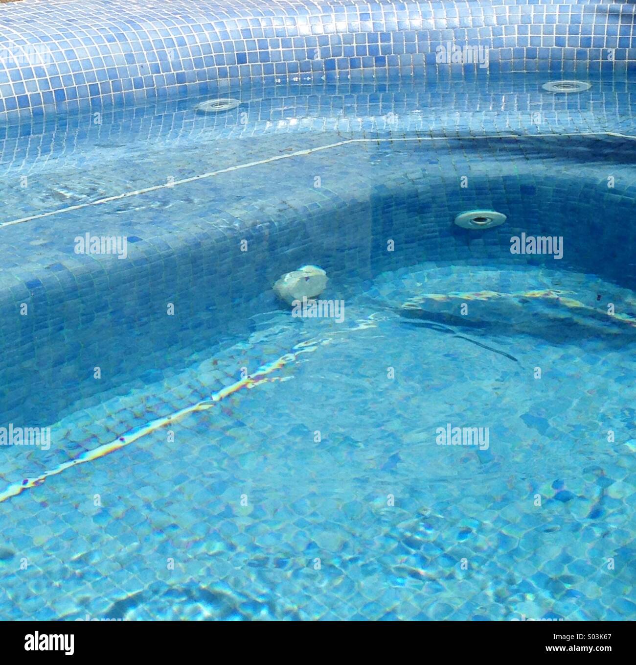Jacuzzi bath corner with blue water ducts in the sunshine Stock Photo ...
