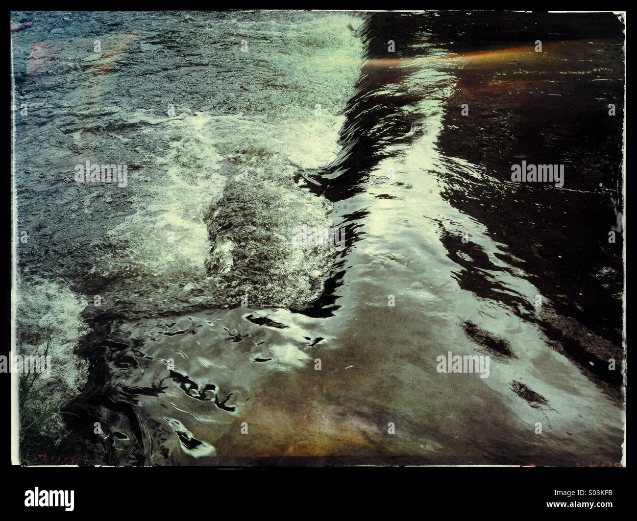 Water running over weir Stock Photo - Alamy