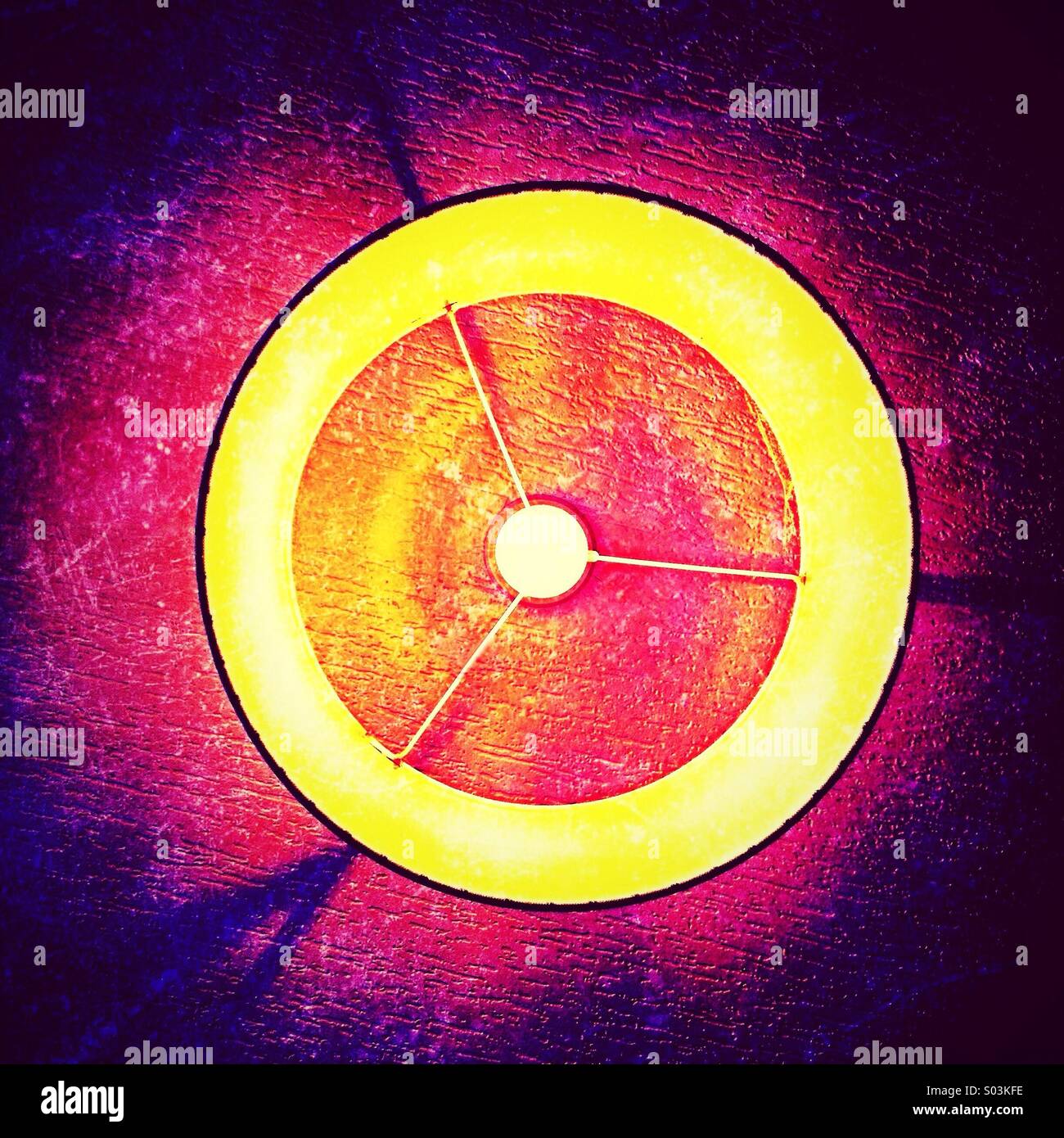 Lit light bulb in lamp shade Stock Photo - Alamy