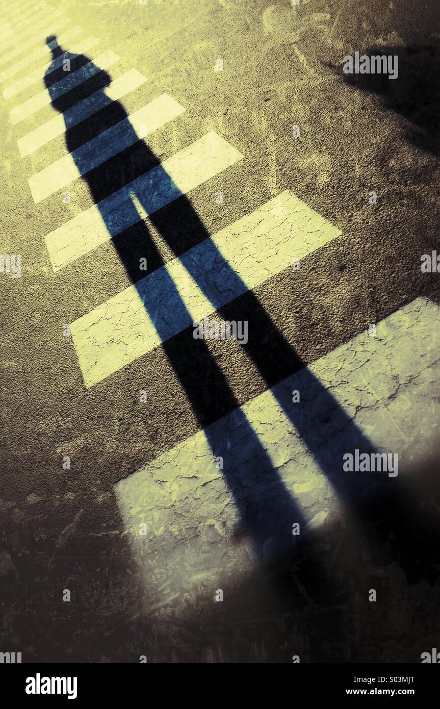 Long shadow cast across pedestrian crossing Stock Photo - Alamy