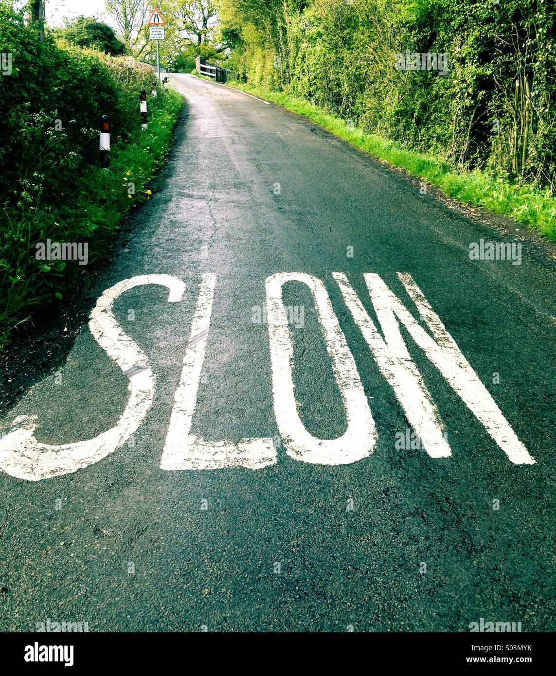 Slow warning sign on country lane, England, UK Stock Photo - Alamy