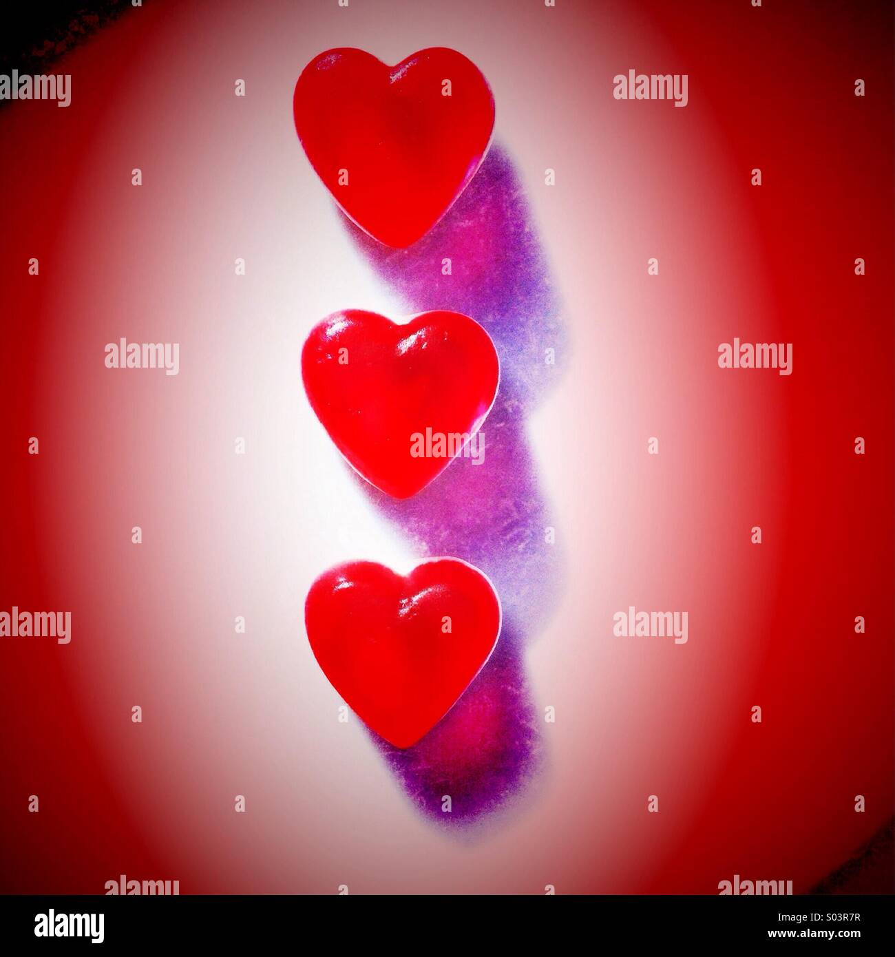 Heart shaped chewy sweets in a line Stock Photo - Alamy