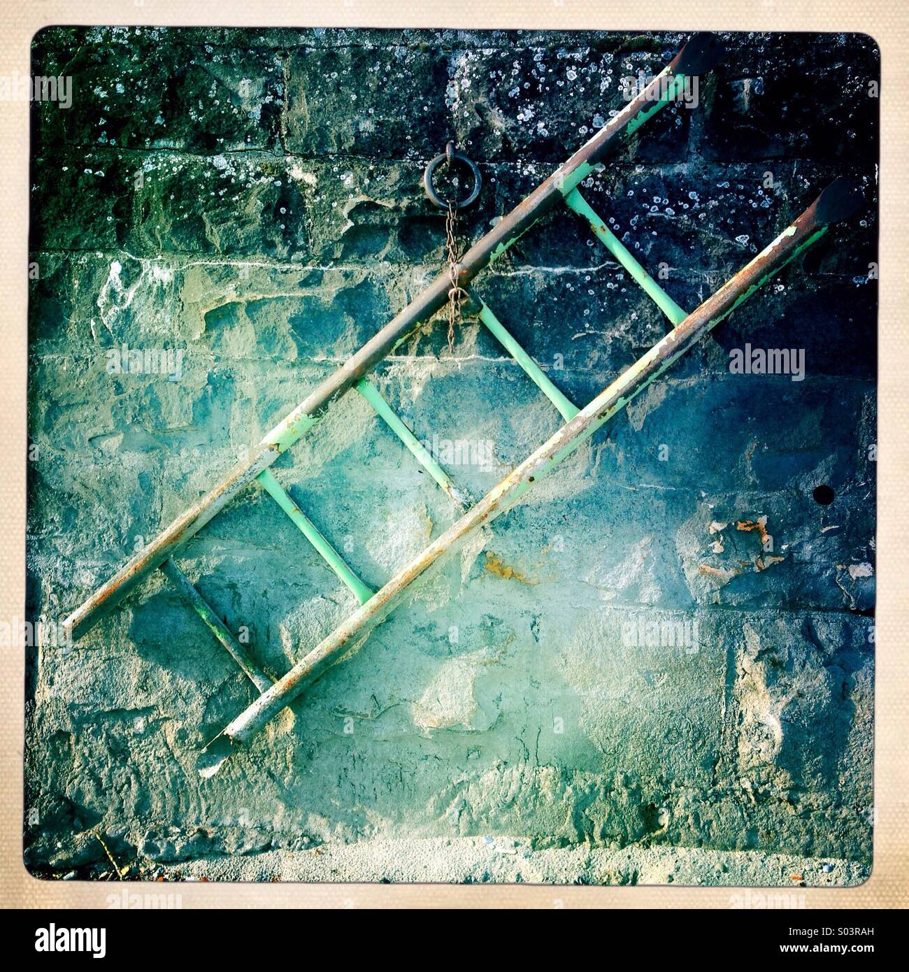 ladder hanging from brick wall Stock Photo - Alamy