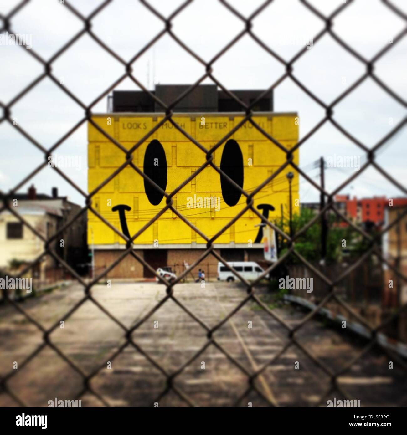 A large smiley face mural painted on the side of a building Stock Photo ...