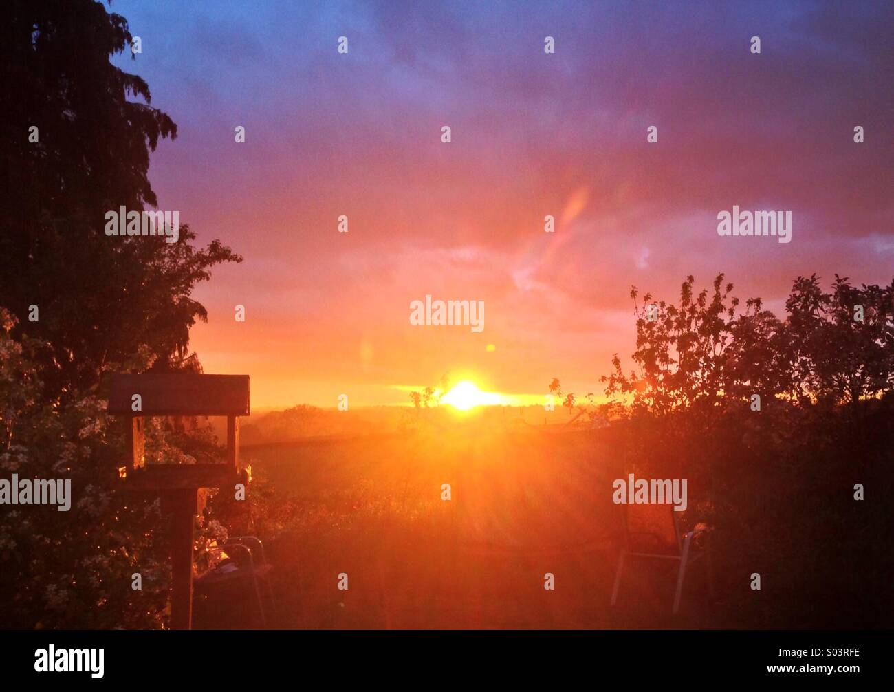Sunset in the rain Stock Photo - Alamy