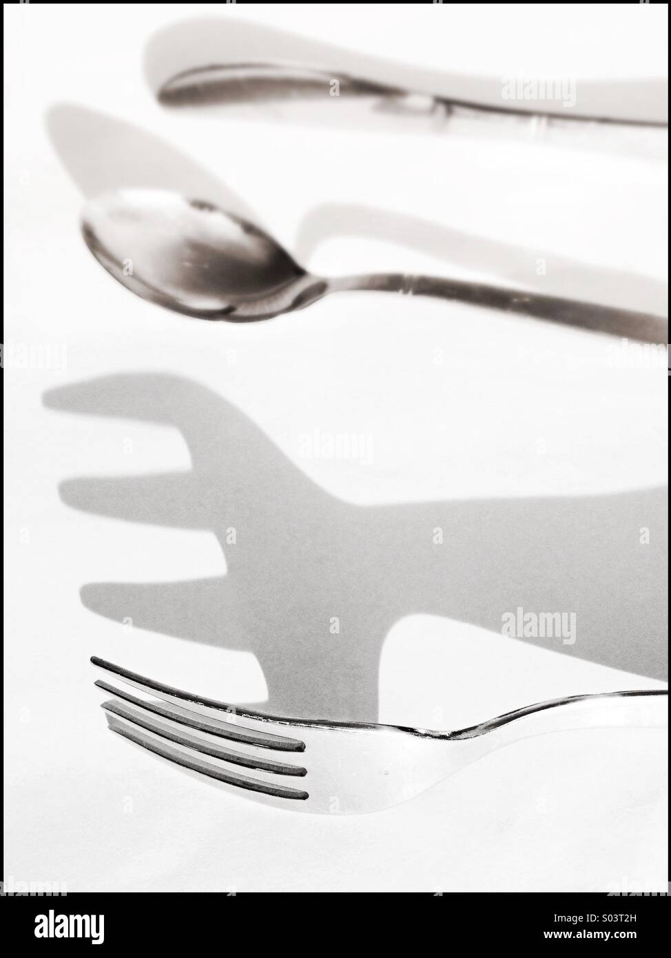 Knife fork and spoon casting shadows Stock Photo - Alamy