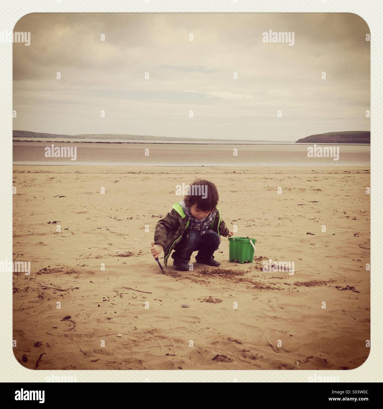 Boy playing on the beach hi-res stock photography and images - Alamy