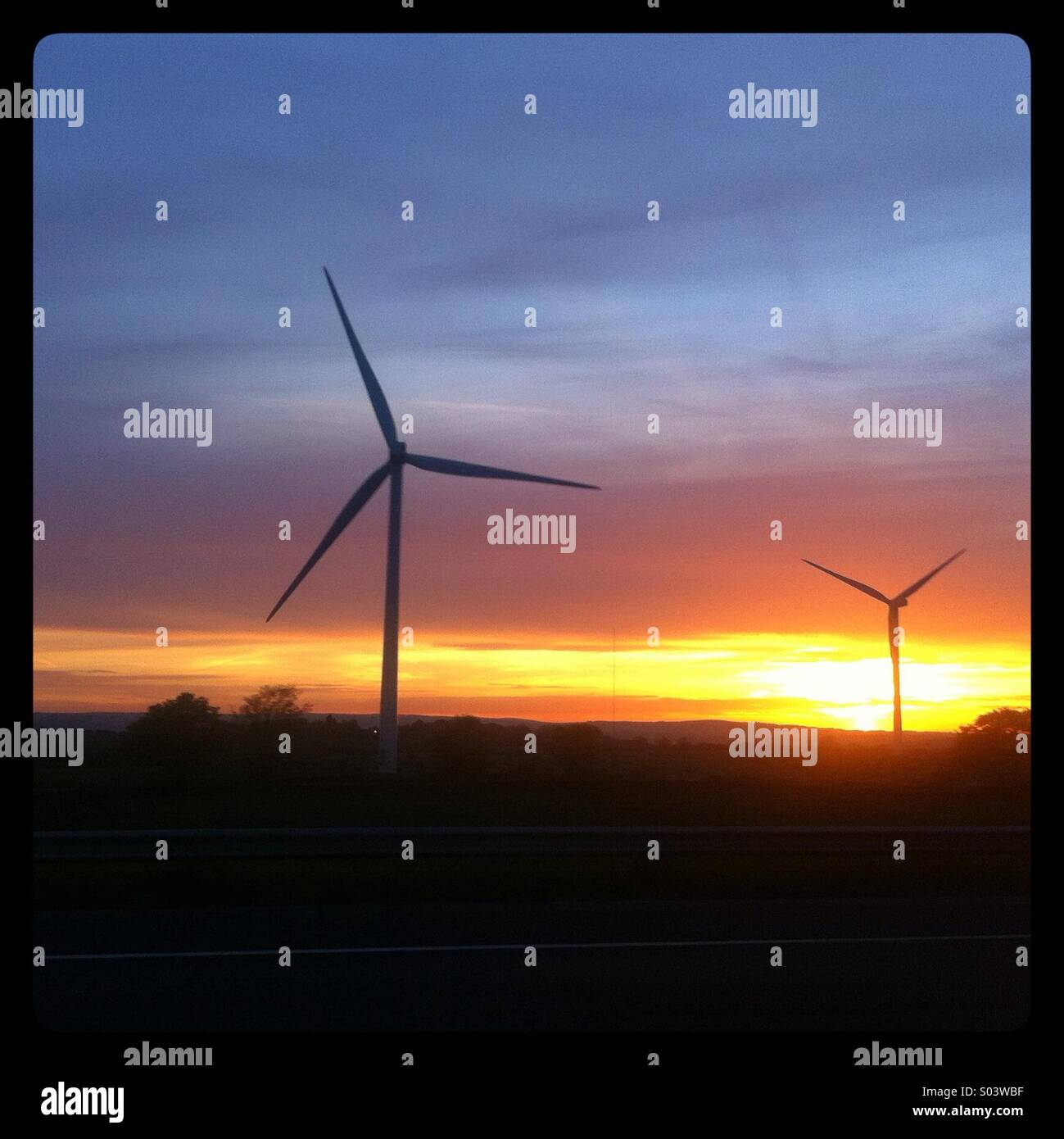 Wind turbines at sunset Stock Photo - Alamy
