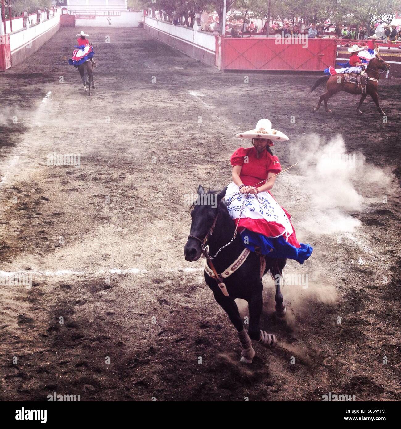 Escaramuza female riders ride their horses during a competition in ...