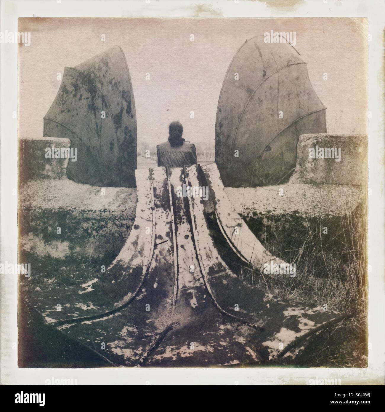 Woman sitting in the midst of a strange steel structure Stock Photo - Alamy