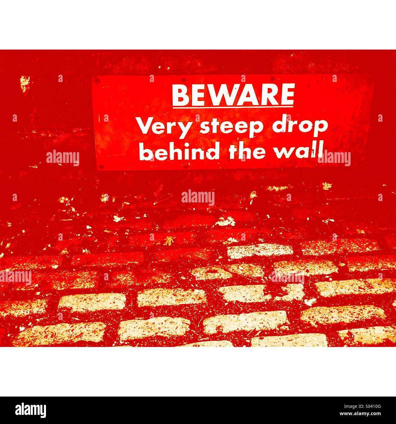 Red danger steep drop warning sign Stock Photo - Alamy