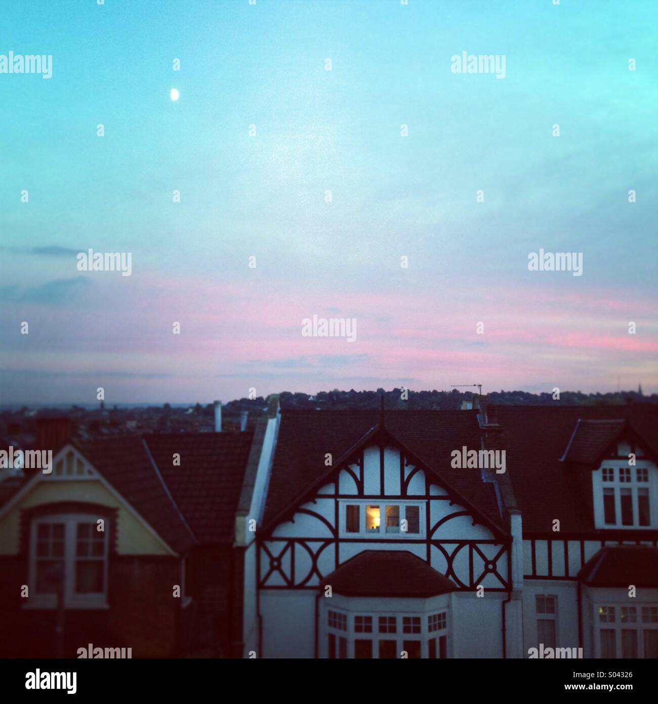 Tudor attached houses at sunset Stock Photo - Alamy