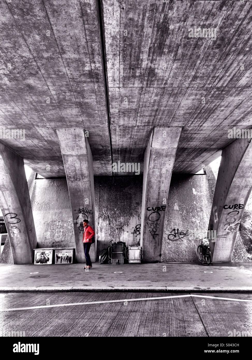 Man under concrete bridge Stock Photo - Alamy