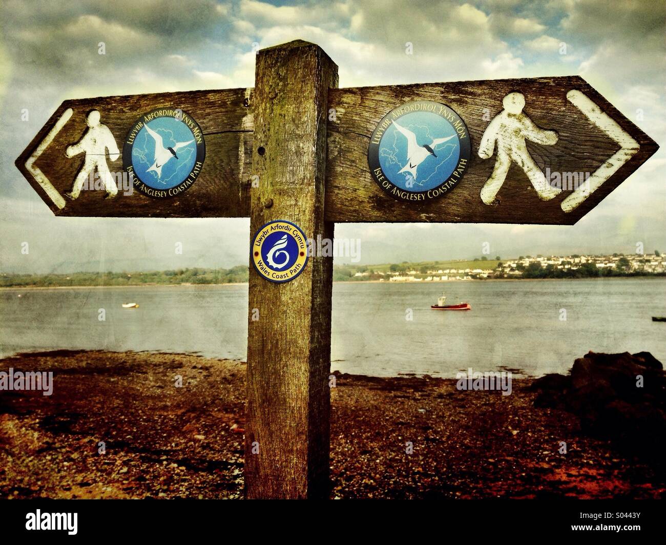 Sign for Anglesey Coastal walk with Menai Strait in background Stock ...