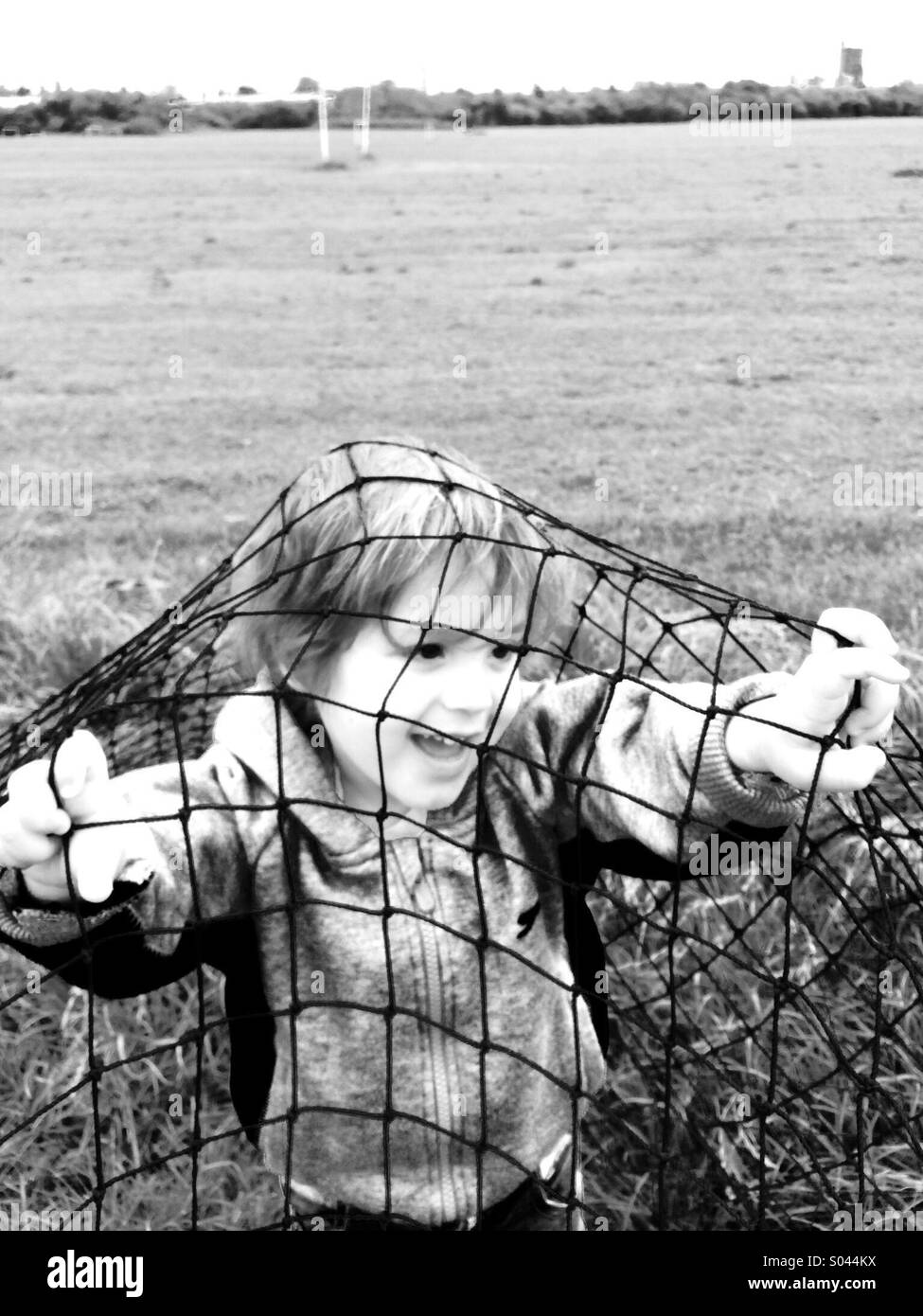 Little boy trapped in football net Stock Photo - Alamy