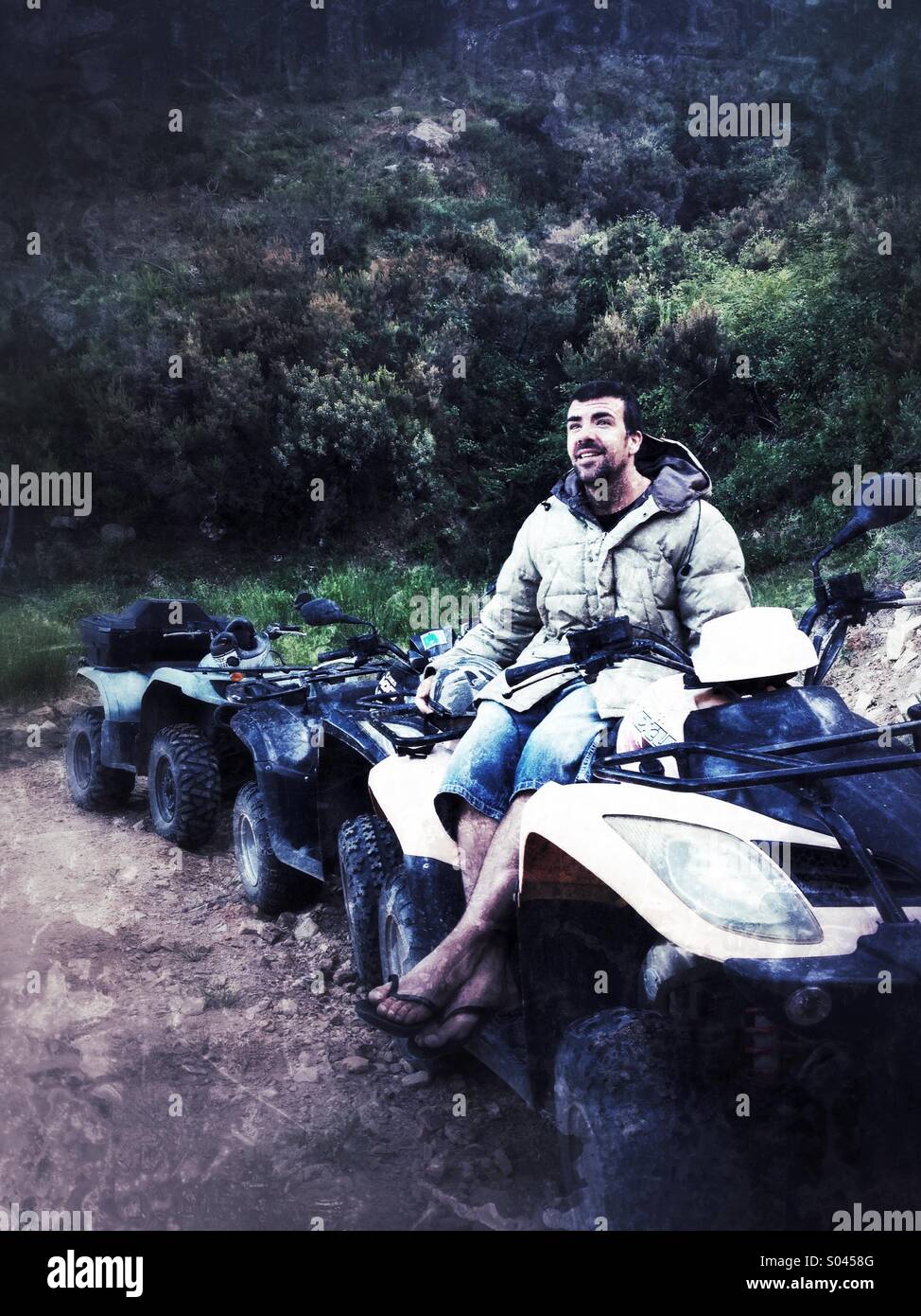 Man sitting on a quad Stock Photo - Alamy