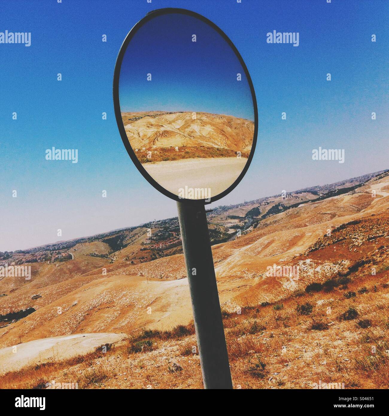 A mirror reflects the Judean Desert in the West Bank settlement of ...