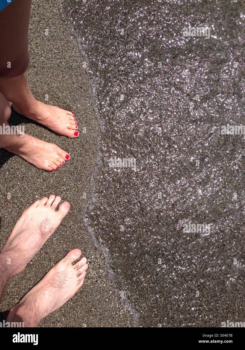 Feet in ocean Stock Photo - Alamy