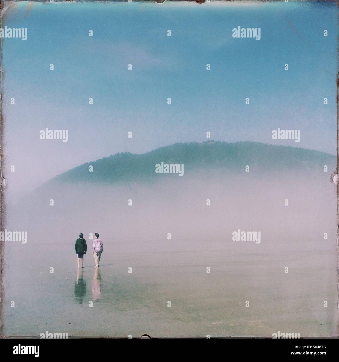 boys in the fog on the beach Stock Photo - Alamy