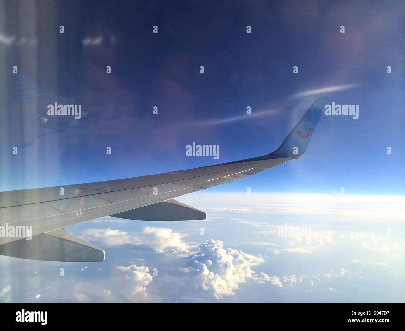 View out of the window of a First Choice passenger jet above the clouds ...