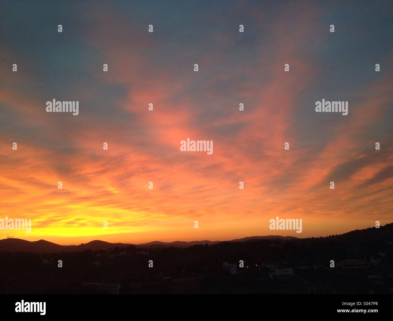 Ibiza sunset red, gold plumes Stock Photo - Alamy