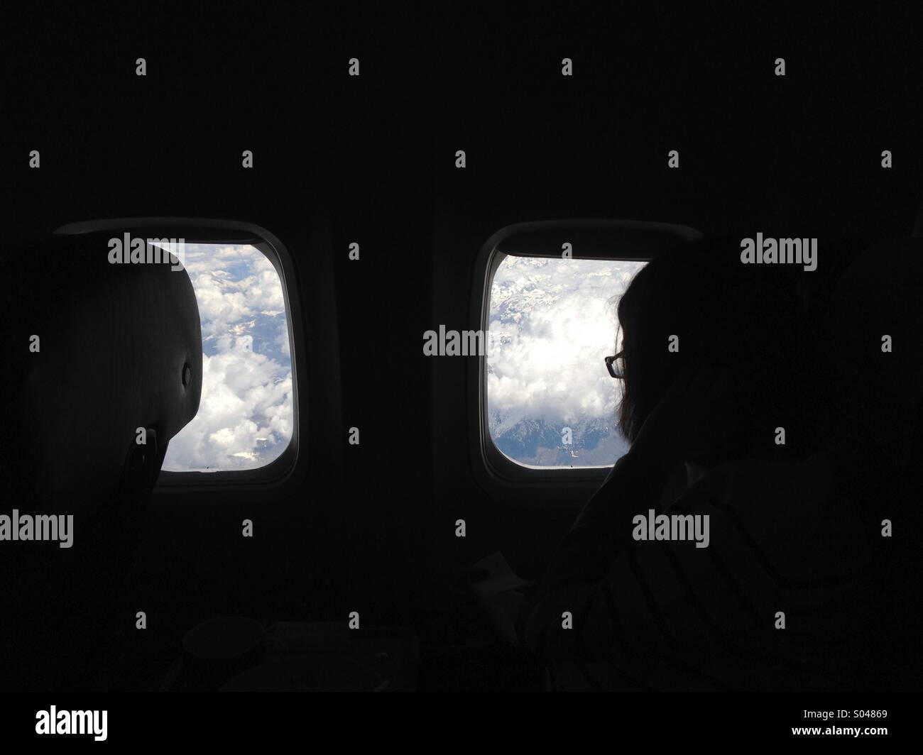 Woman looking out window of plane hi-res stock photography and images ...