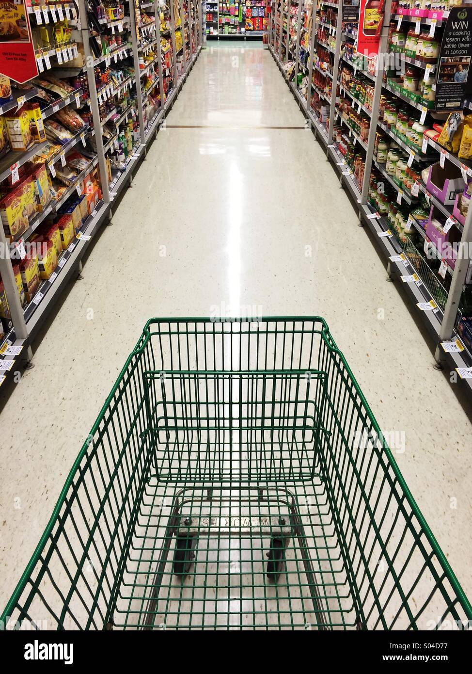 Empty shopping trolley in a passageway in a shop Stock Photo - Alamy
