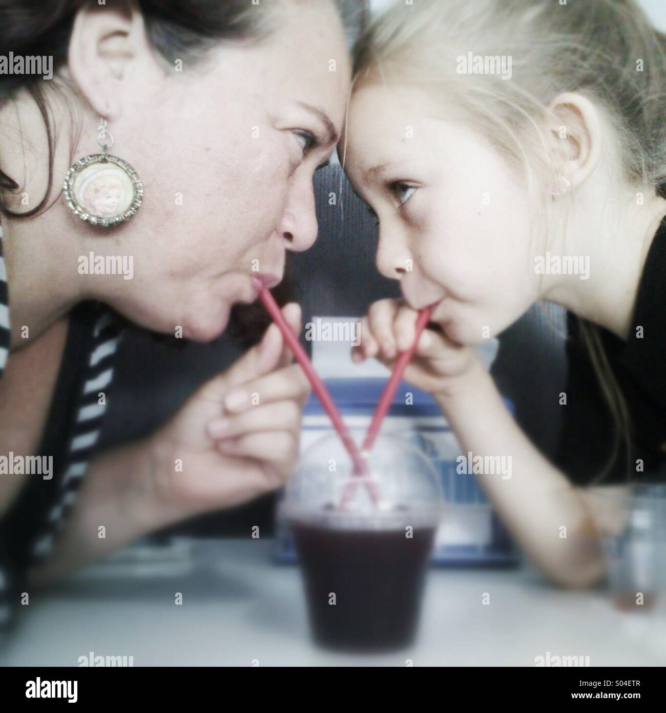 Mother and daughter drinking a slushie Stock Photo - Alamy