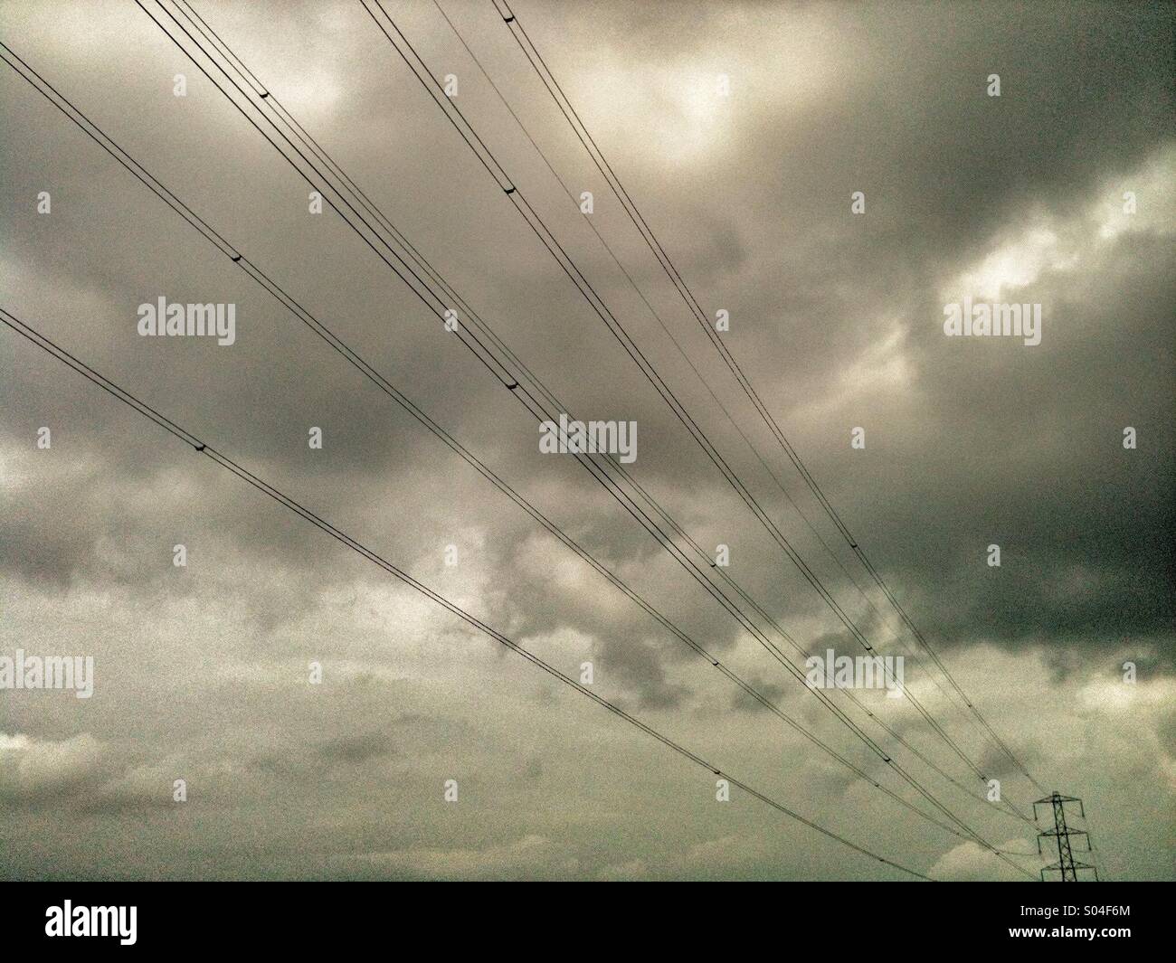 Electricity power lines and grey sky Stock Photo - Alamy