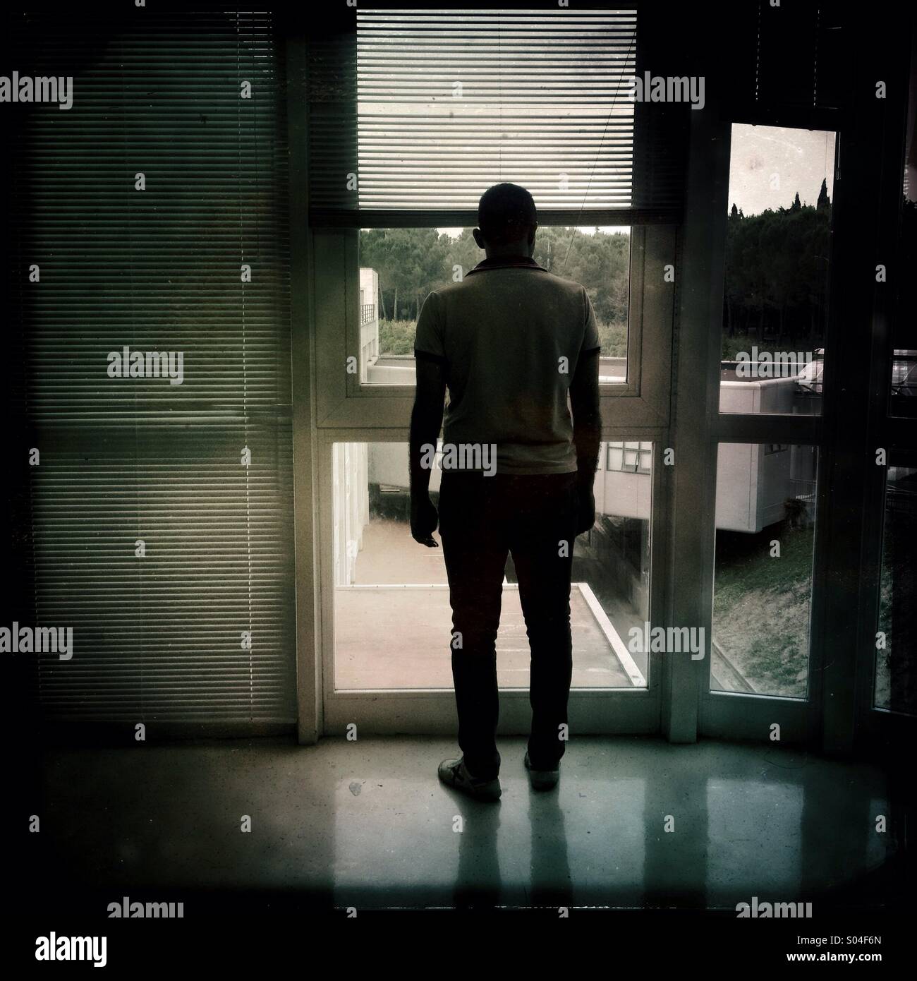 Man watching through a window Stock Photo - Alamy