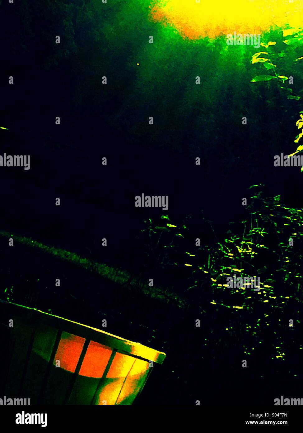 Rays of sunlight shining on garden and yellow bucket Stock Photo - Alamy