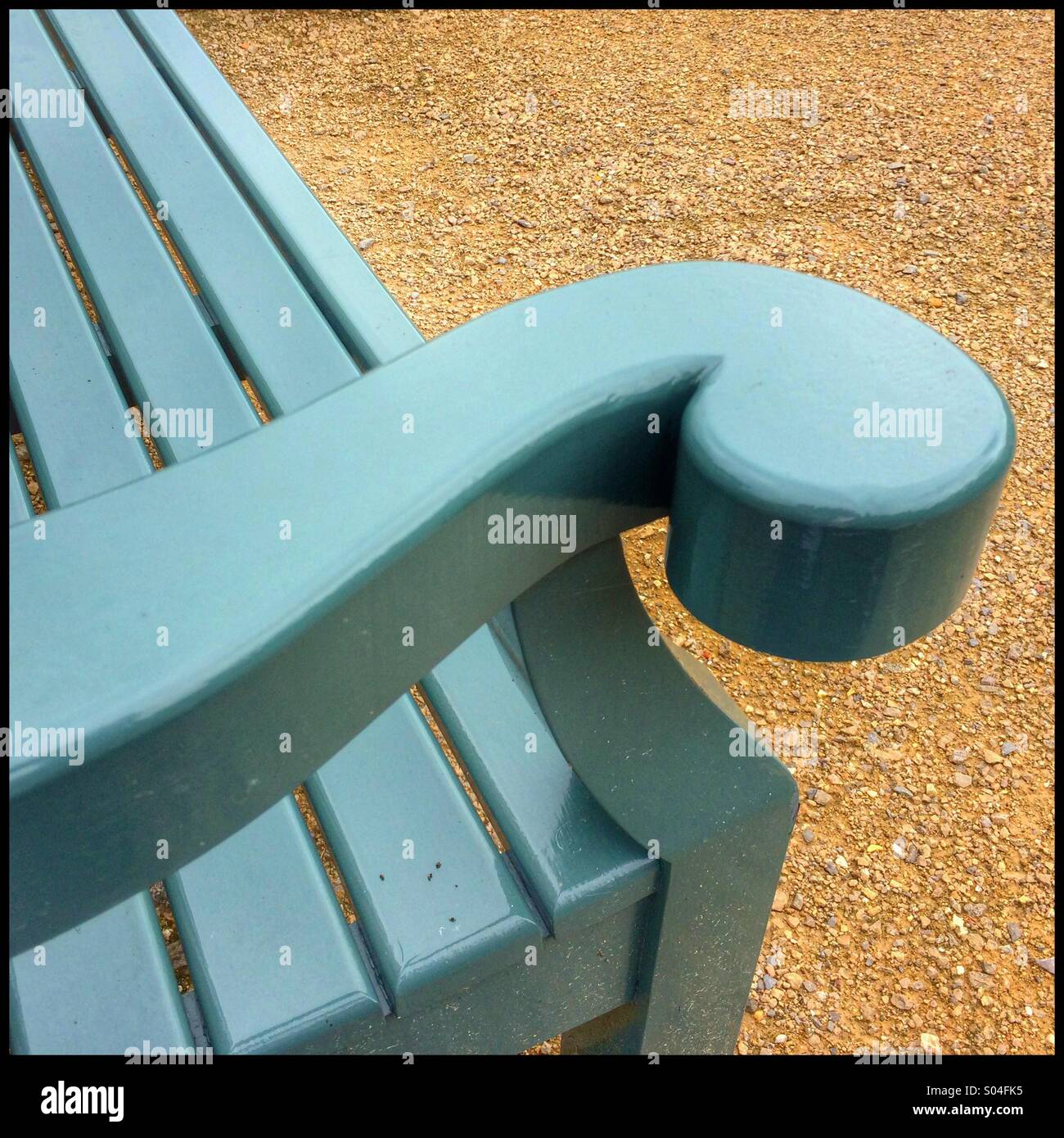 Scroll shaped arm and seat on a painted wooden bench Stock Photo - Alamy