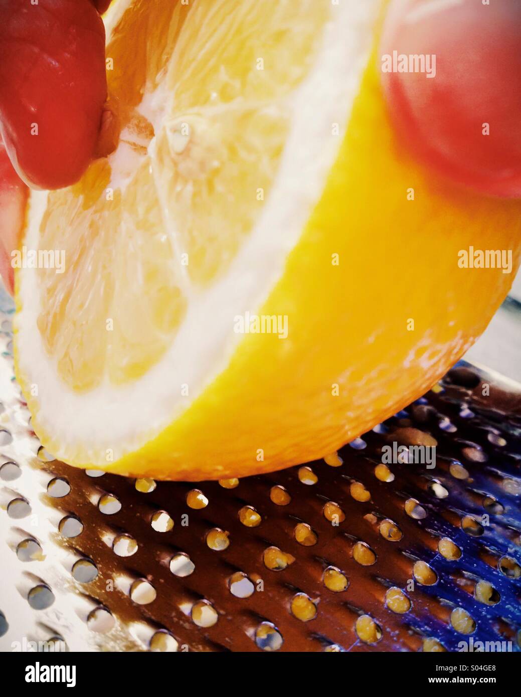 Grating fresh Lemon Stock Photo - Alamy