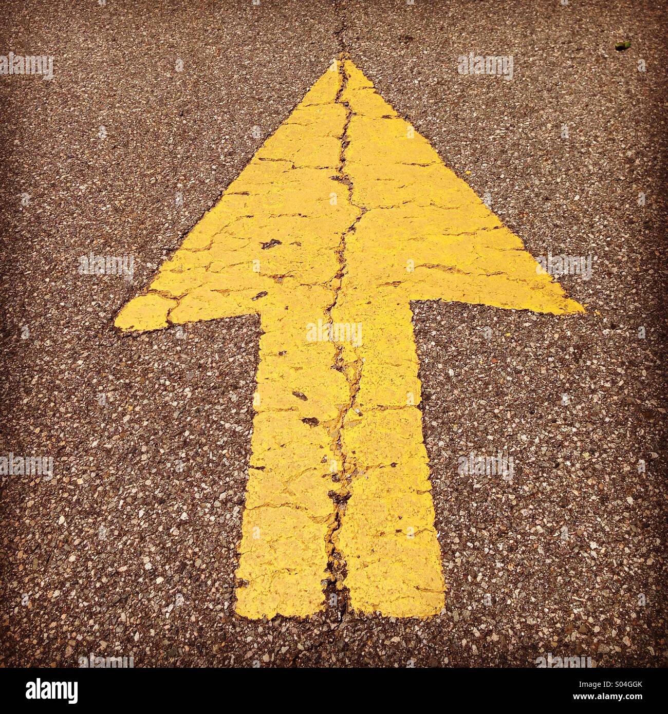 Broken painted yellow arrow pointing up Stock Photo - Alamy