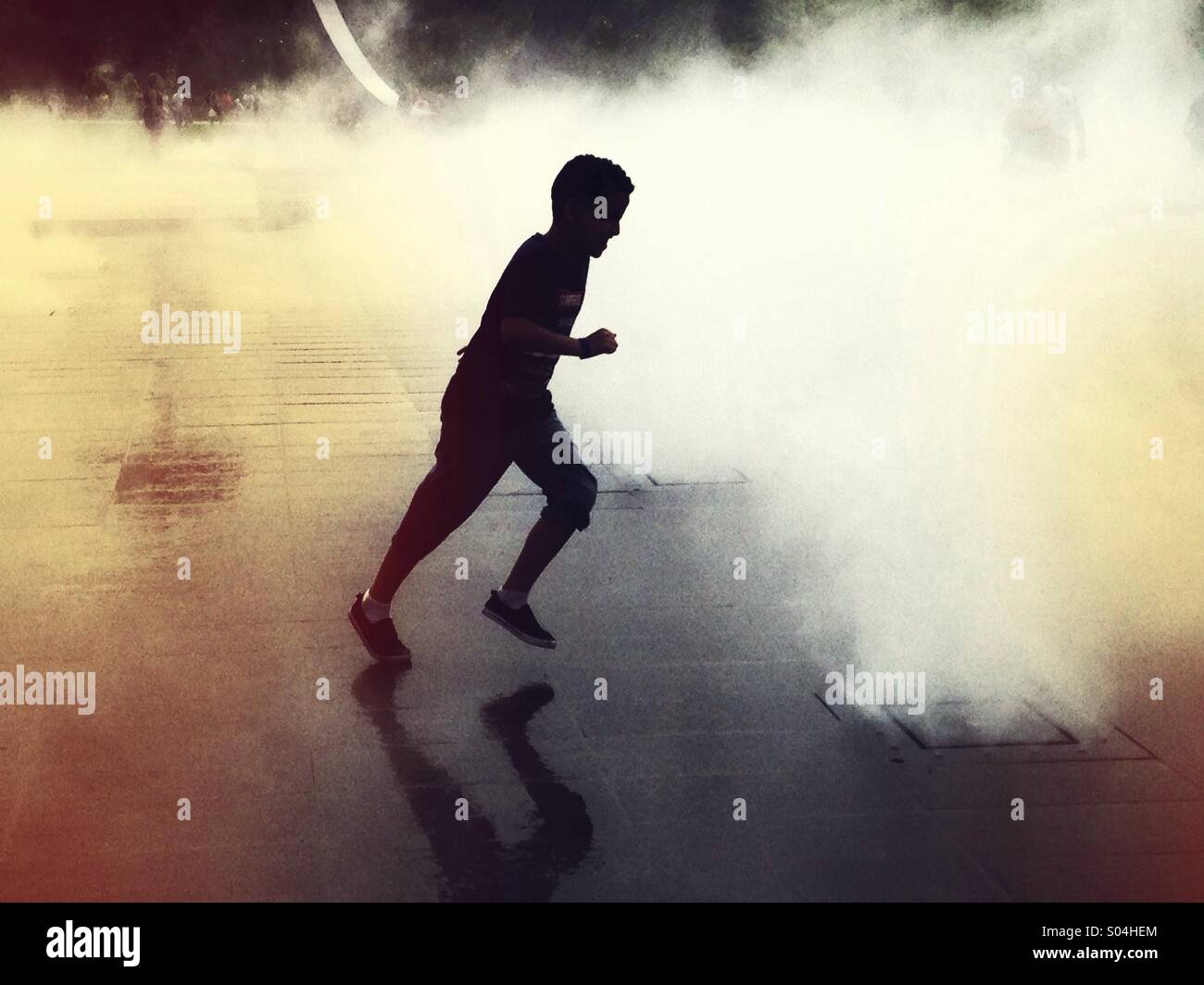 Silhouette of a boy running through the mist Stock Photo - Alamy