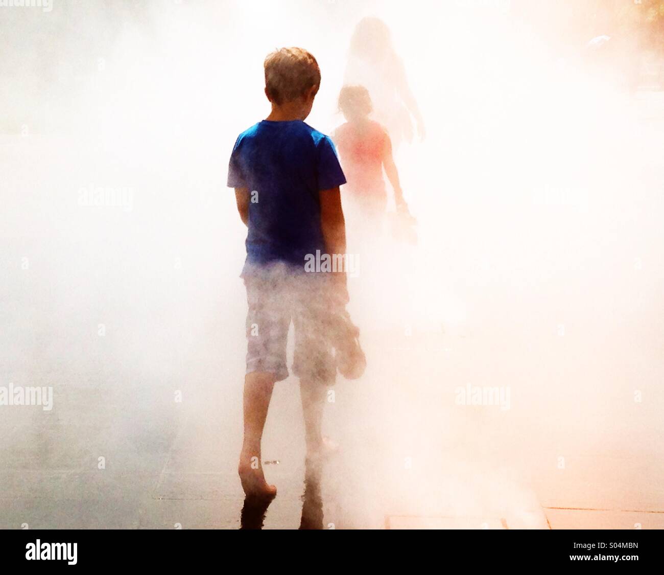 Young man in the mist amidst shadows Stock Photo - Alamy