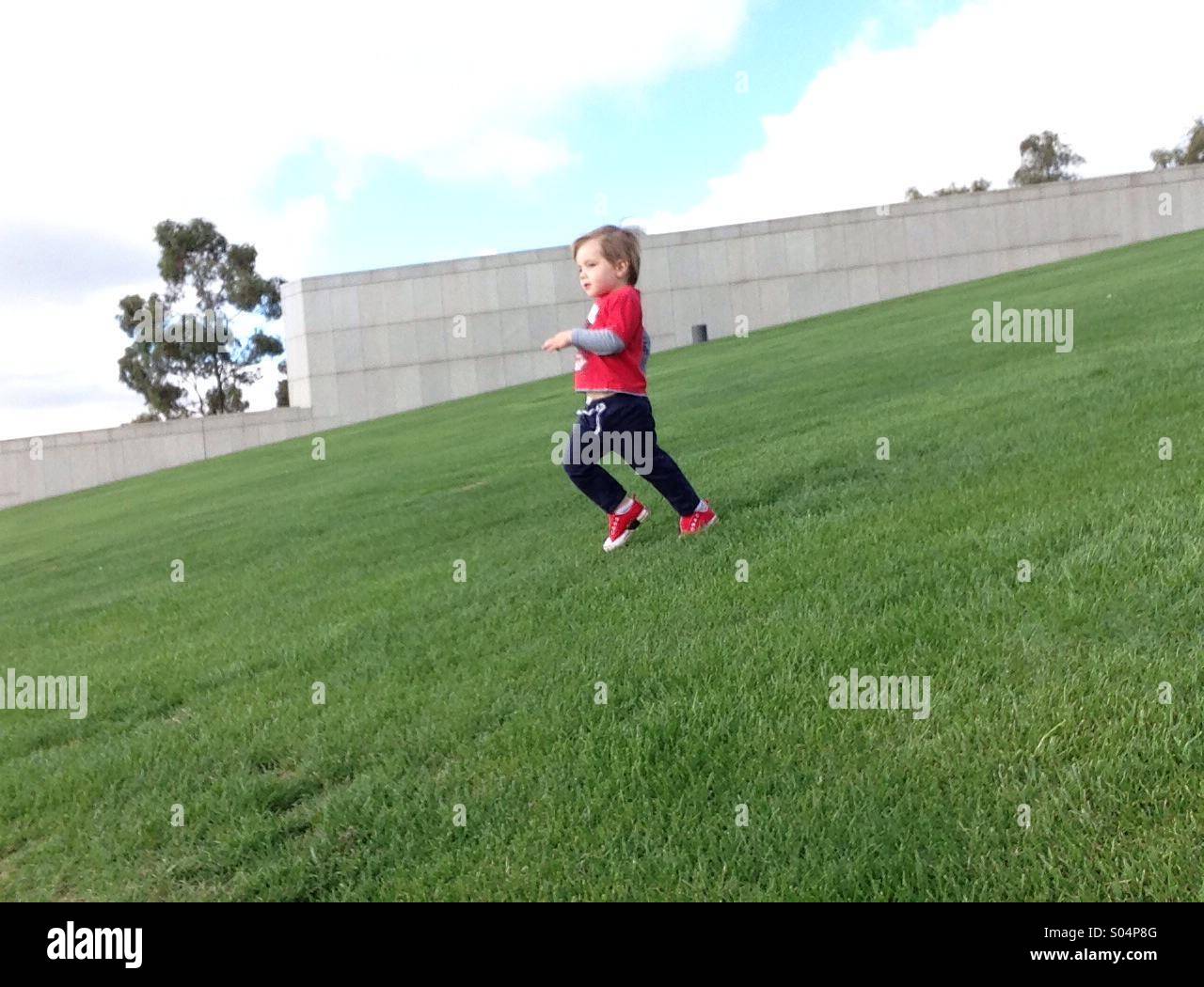 Boy running down hill hi-res stock photography and images - Alamy