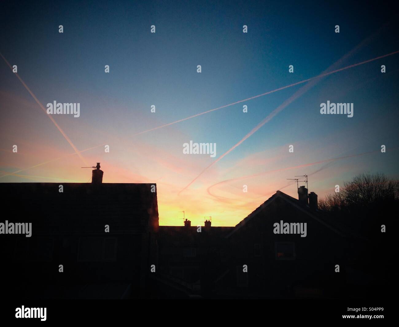 Sunrise over houses Stock Photo - Alamy