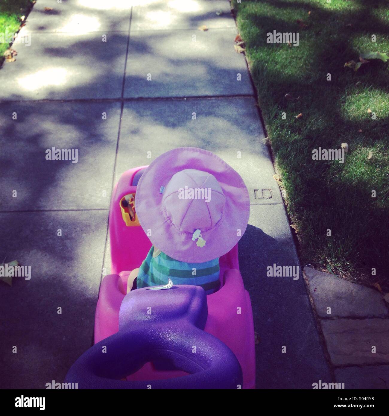 My daughter loves to stroll in her car around the block everyday Stock ...