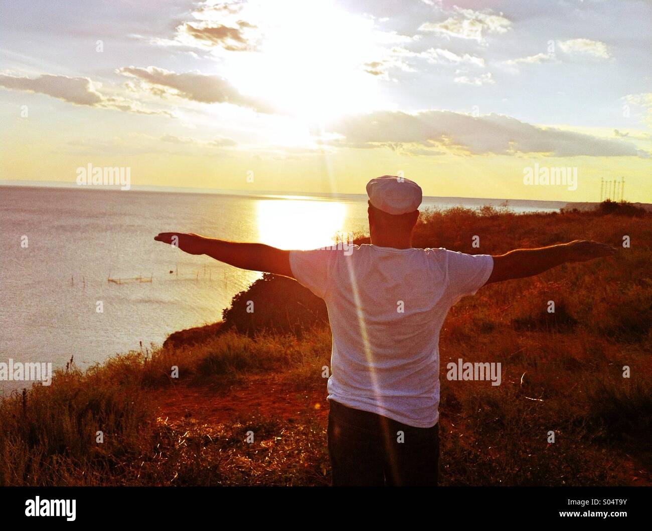 Man and sunrise, Black sea Stock Photo - Alamy