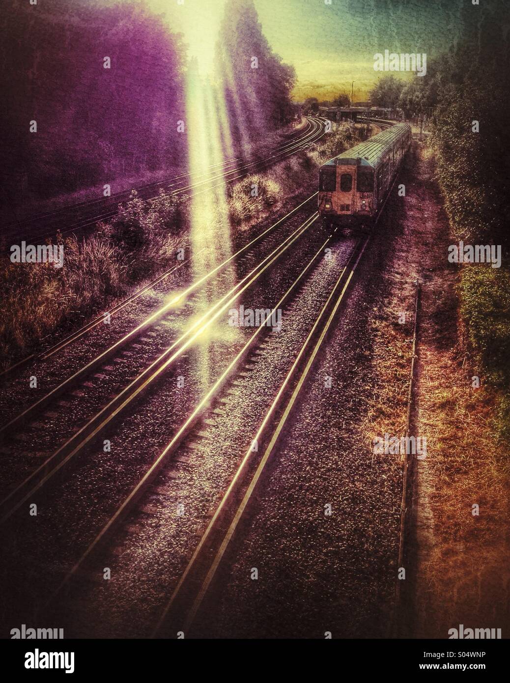 Train pulling out of station with sun rays streaming down not tracks ...