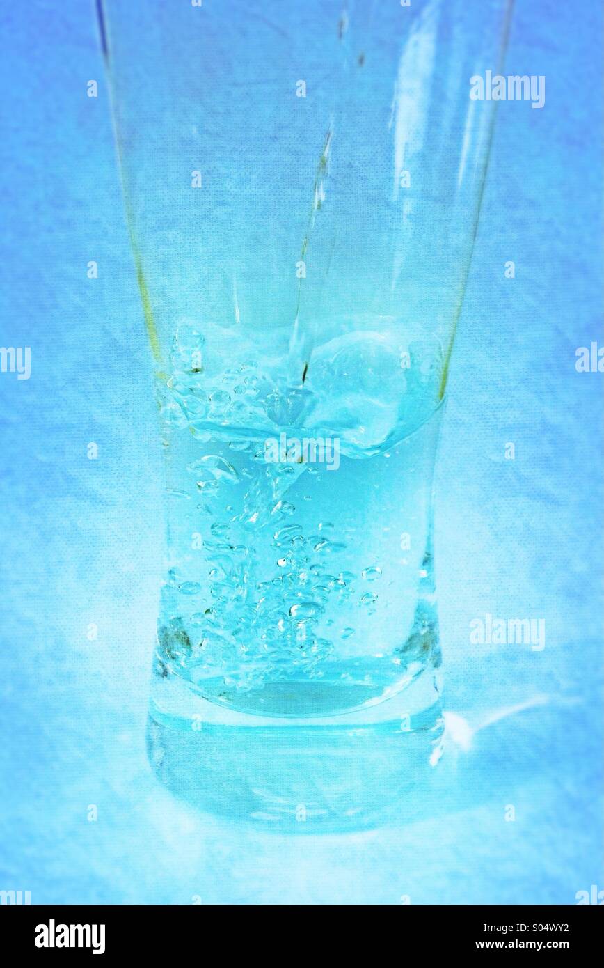 Pouring water into glass Stock Photo - Alamy