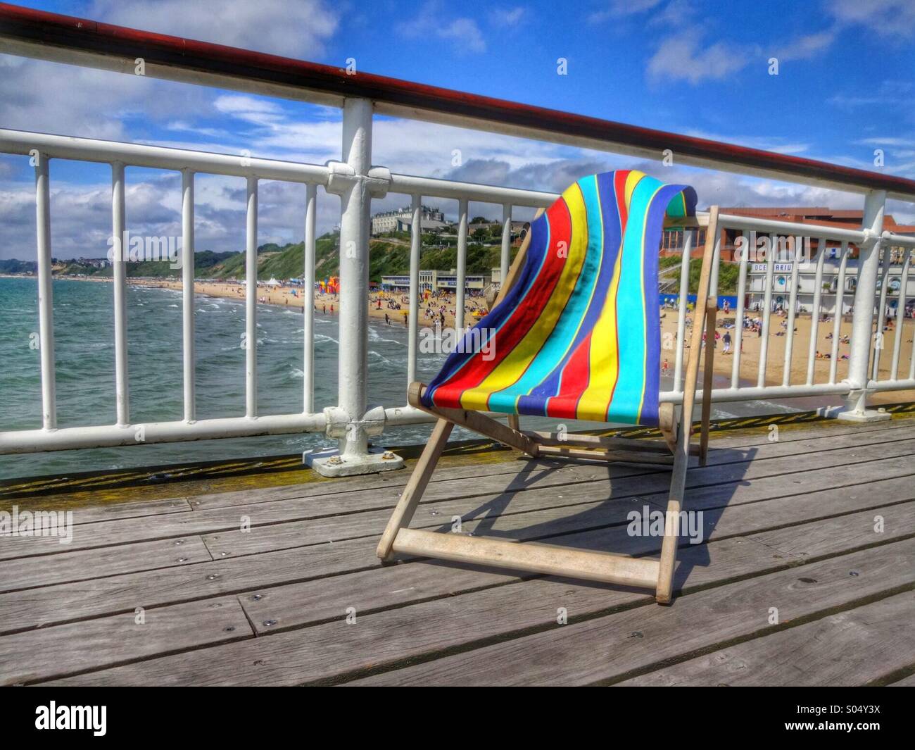 Bright and colourful deck chair blowing in the wind Stock Photo - Alamy