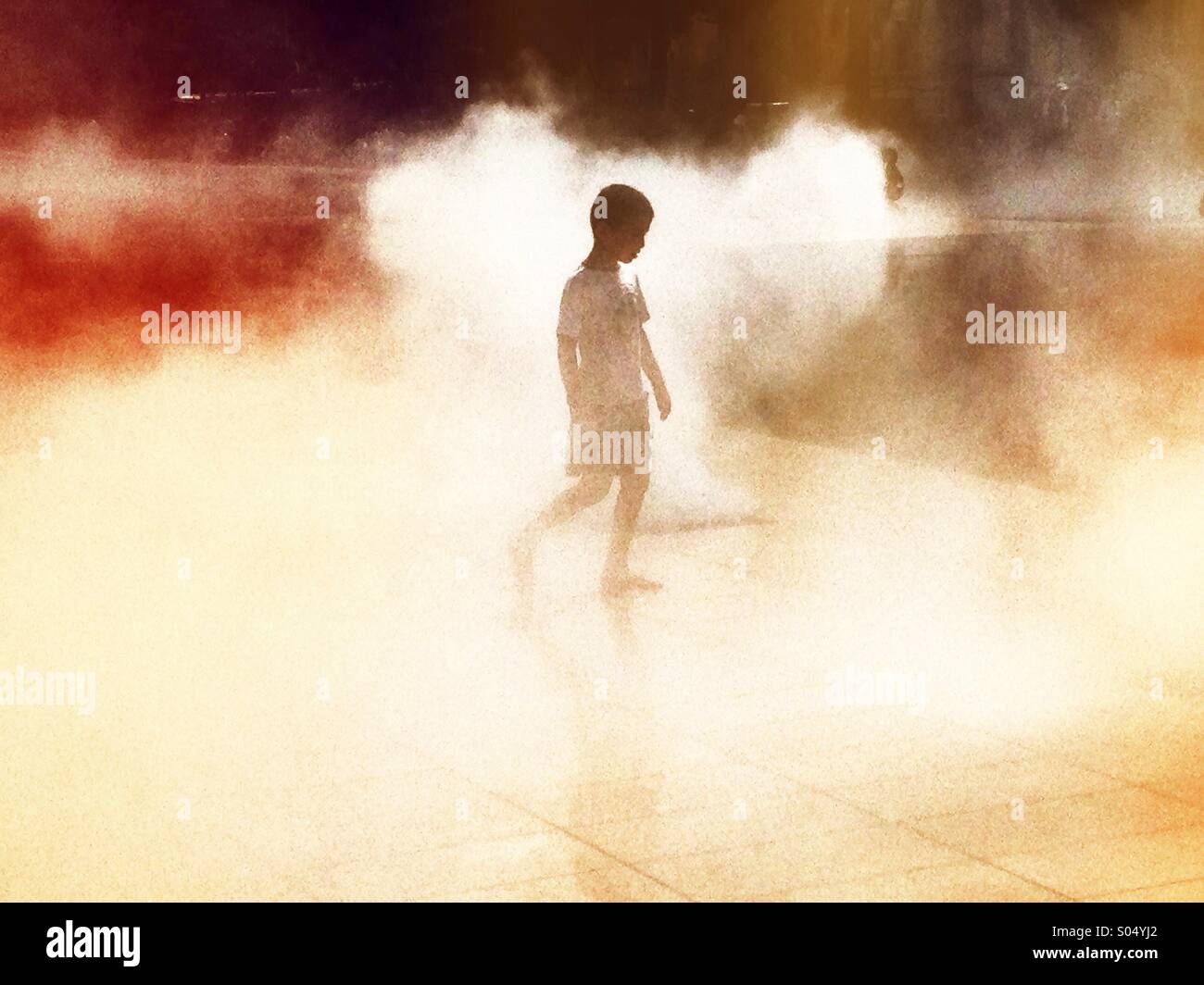 Boy in the mist Stock Photo - Alamy